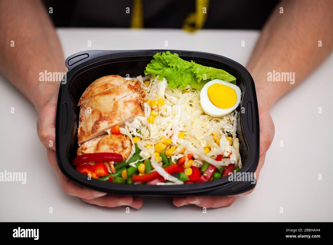 Closeup of a man holding a box full of protein rich foods for sports ...