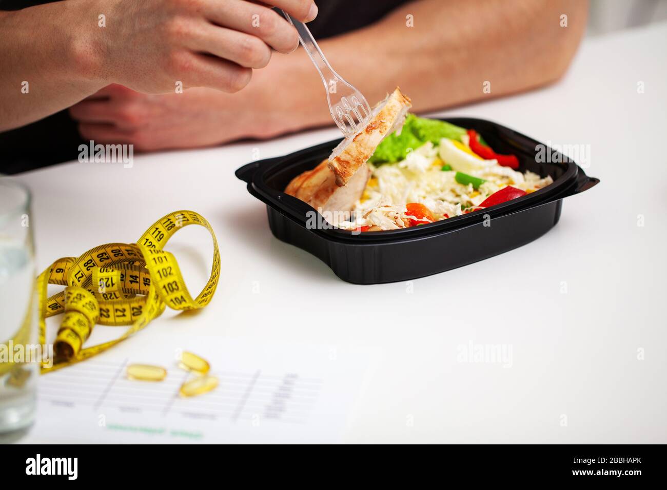 Closeup of a man holding a box full of protein rich foods for sports ...