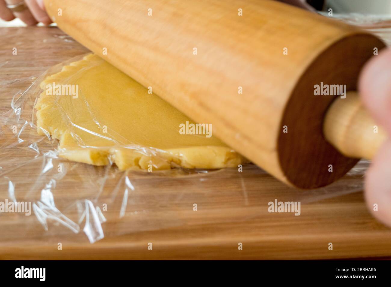 Roll out dough with rolling pin Stock Photo - Alamy