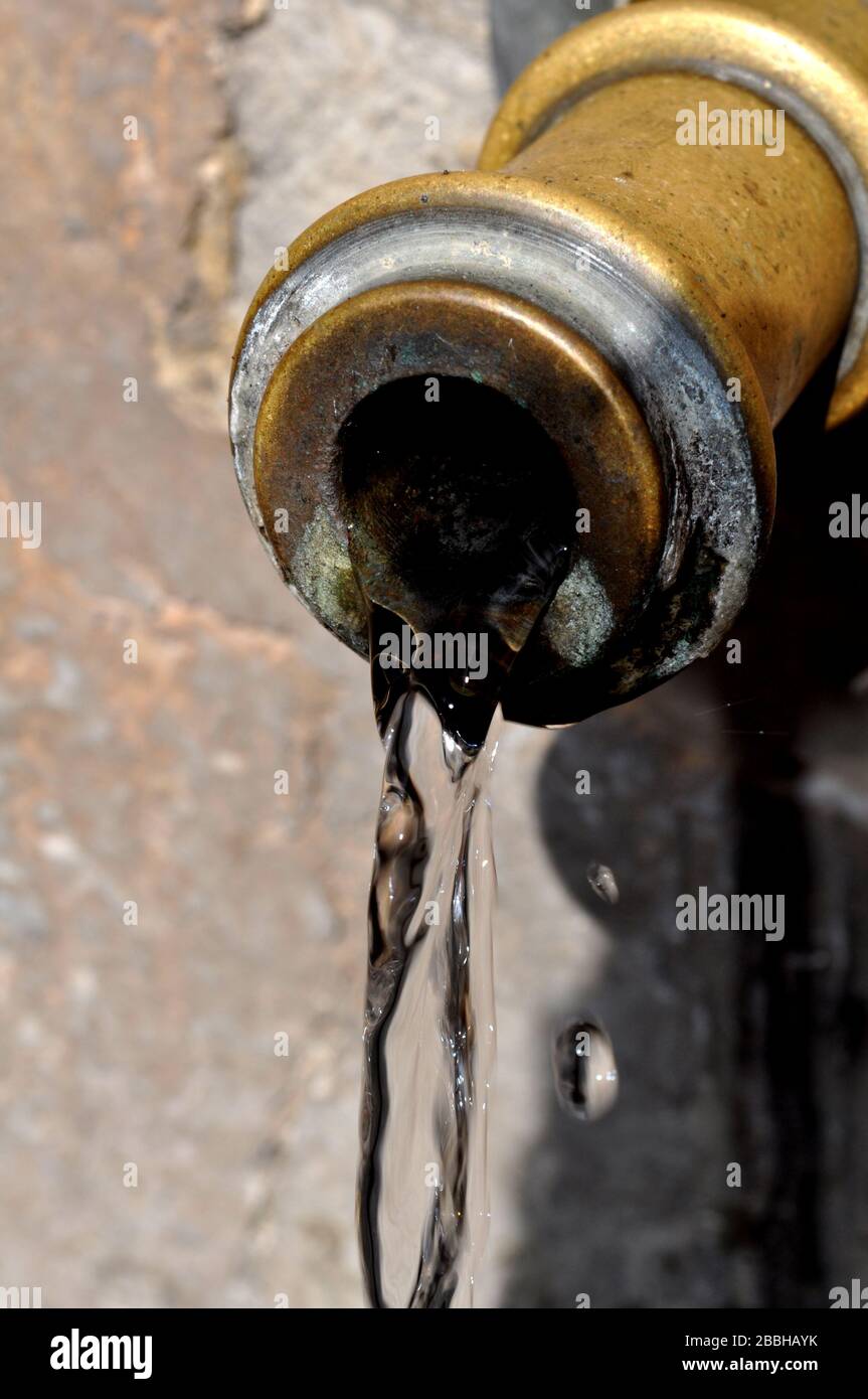 ancient fountain with brass tap Stock Photo - Alamy