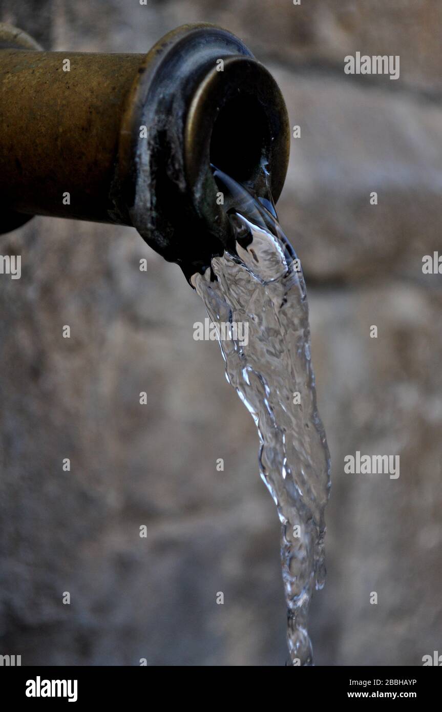 Faucet of an ancient fountain Stock Photo - Alamy