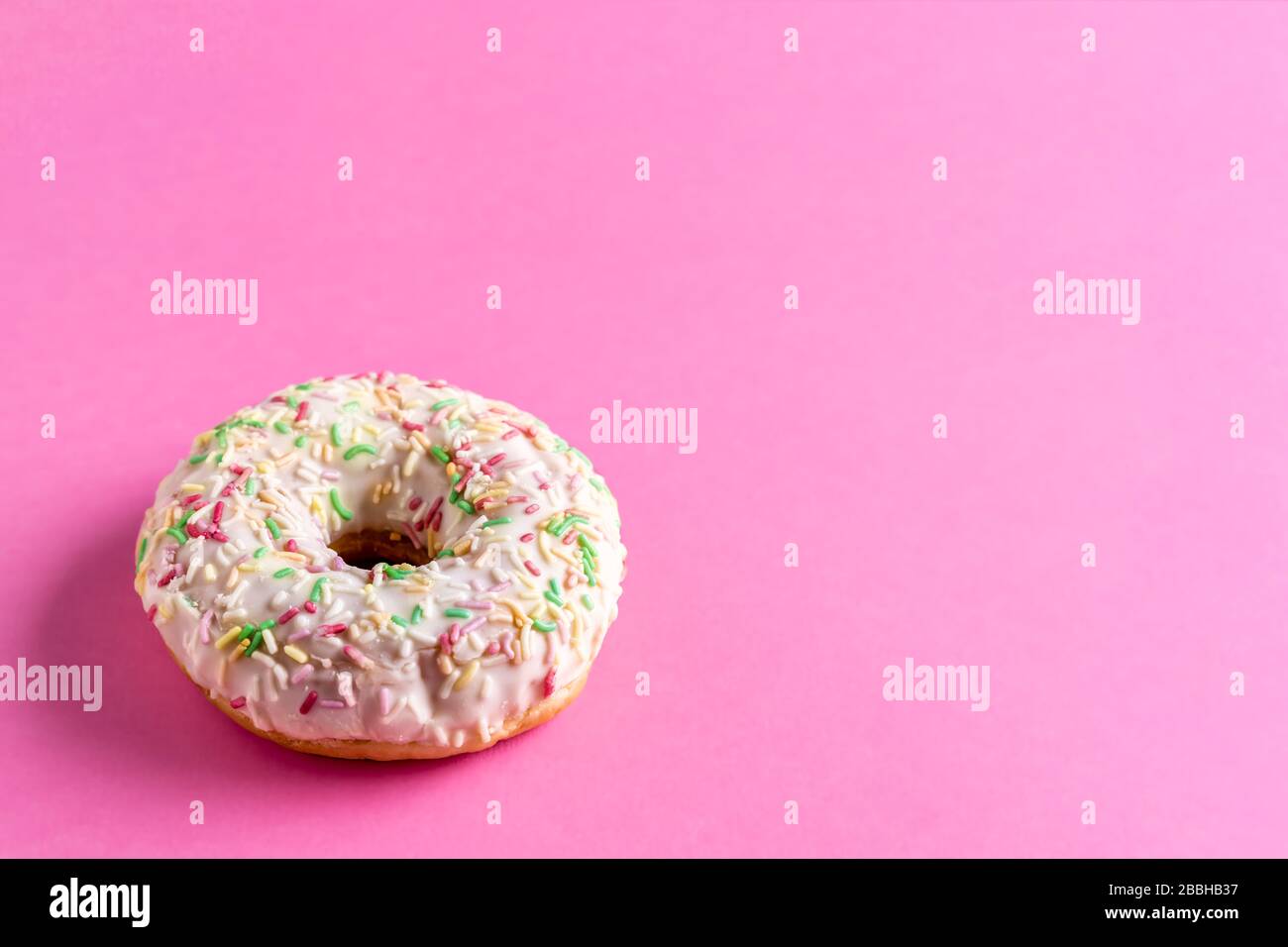 Top view Pink frosting donut on pink background Stock Photo - Alamy