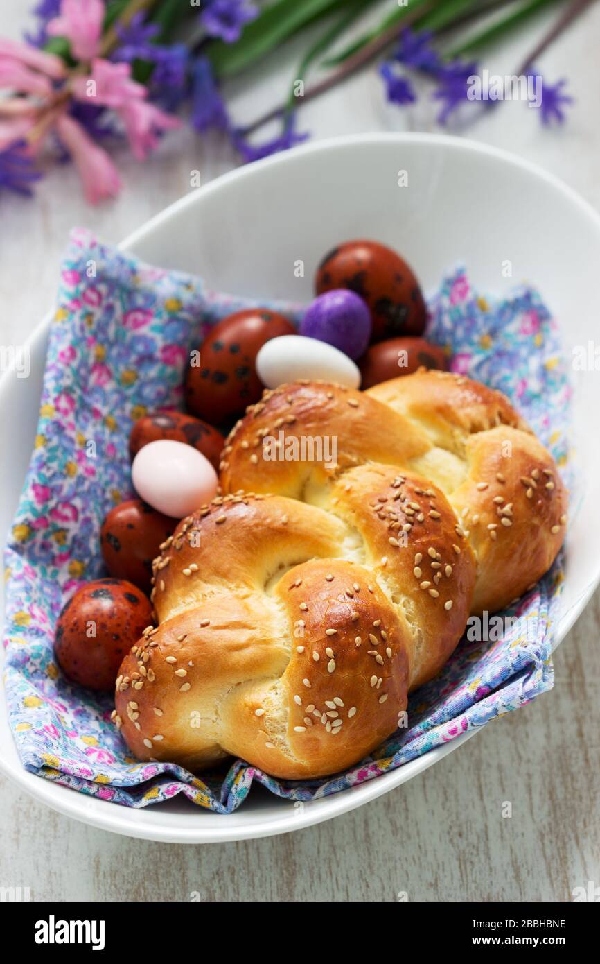 Easter bun, colored eggs and flowers on a white background Stock Photo ...
