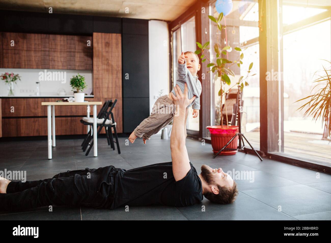 Father playing and lifting baby in the air and doing exercise Stock ...