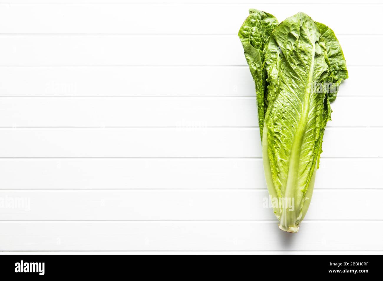 Fresh green Romaine Lettuce. Leaves of Lactuca sativa on white table. Top view Stock Photo - Alamy
