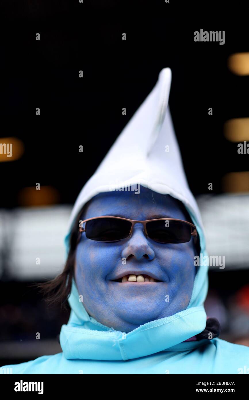 A Birmingham City fan dressed as a smurf in the stands Stock Photo - Alamy