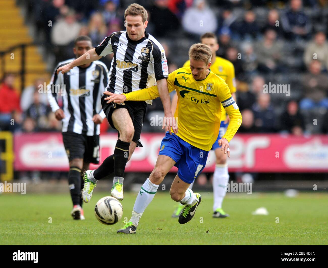 Coventry City's Carl Baker (right) and Notts County's Alan Judge battle ...