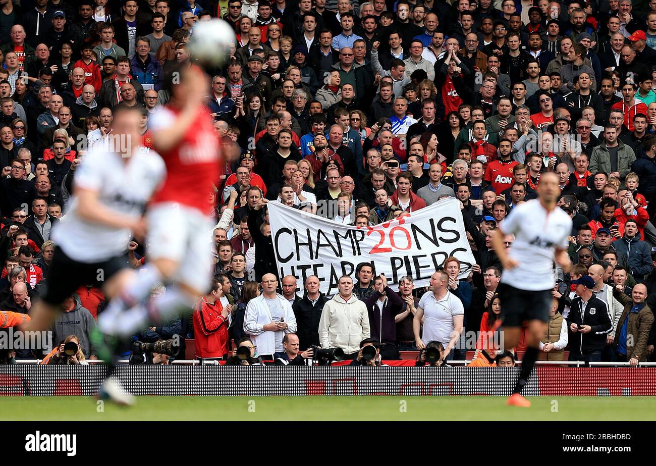Manchester United fans hold up a banner celebrating their 20 league ...