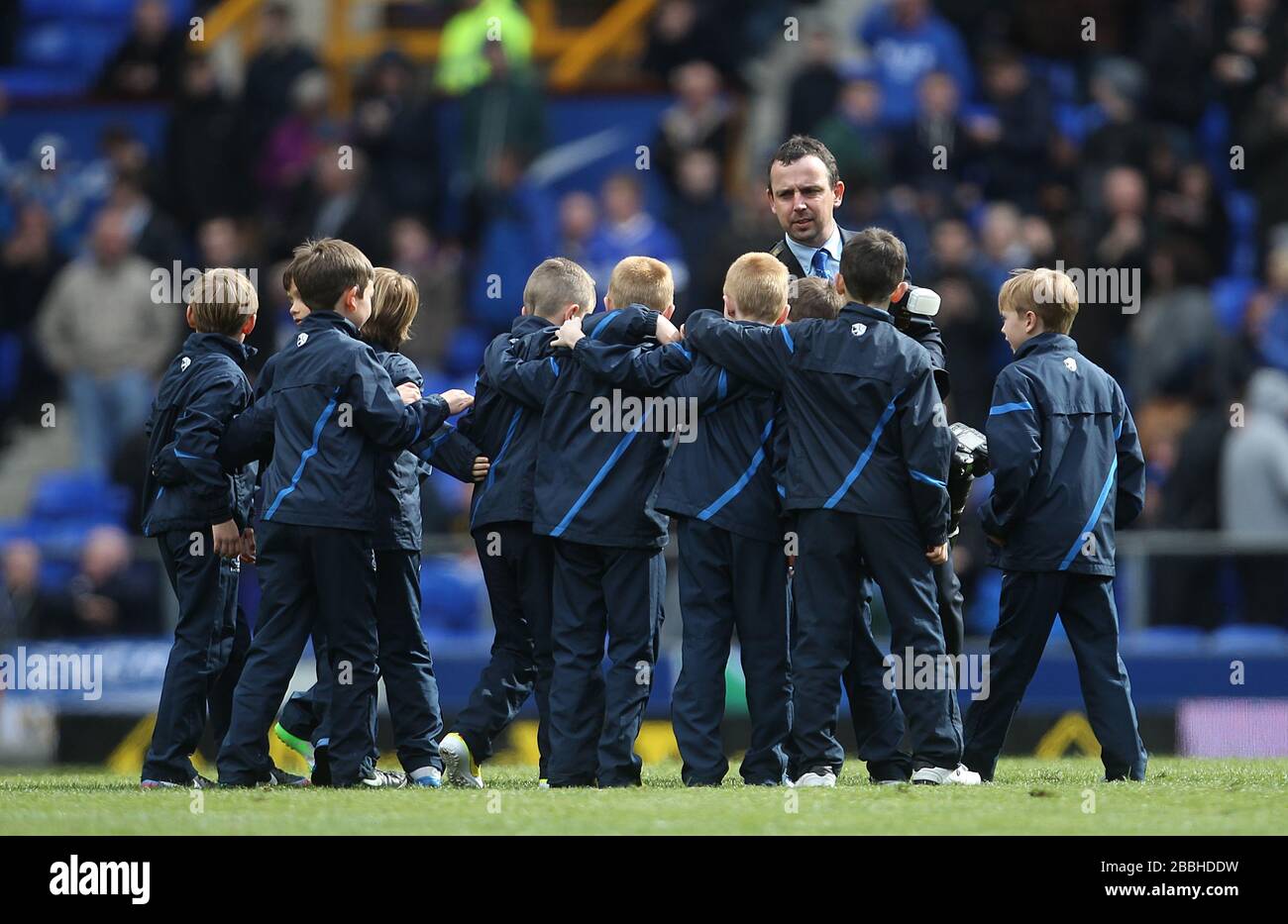 Everton mascots on the pitch Stock Photo - Alamy