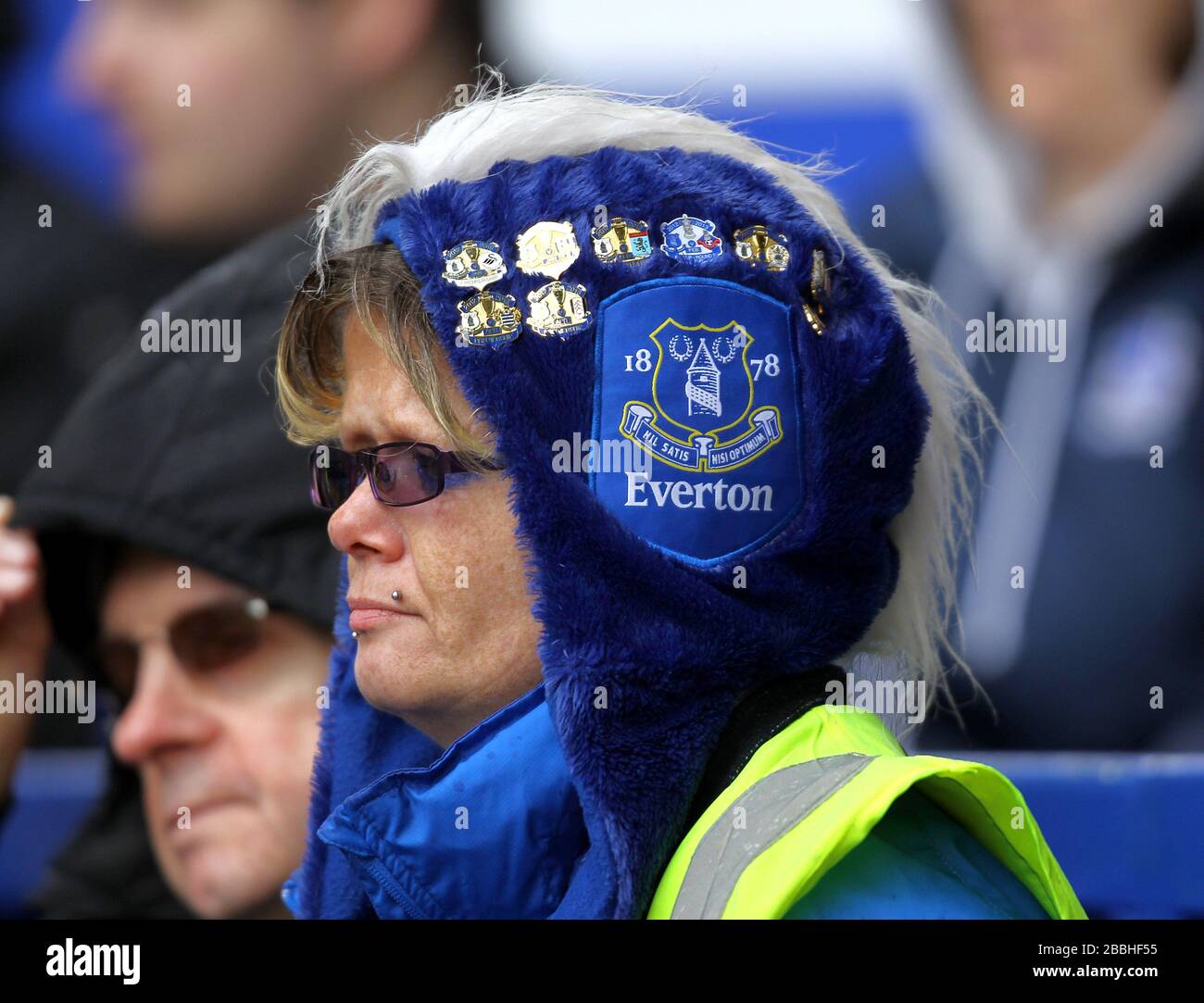 An Everton fan shows off their collection of enamel badges on a hat in ...
