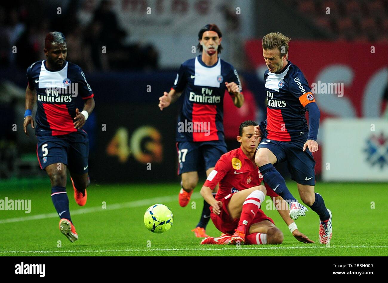 Paris Saint-Germain's David Beckham (right) gets awat from Stade ...