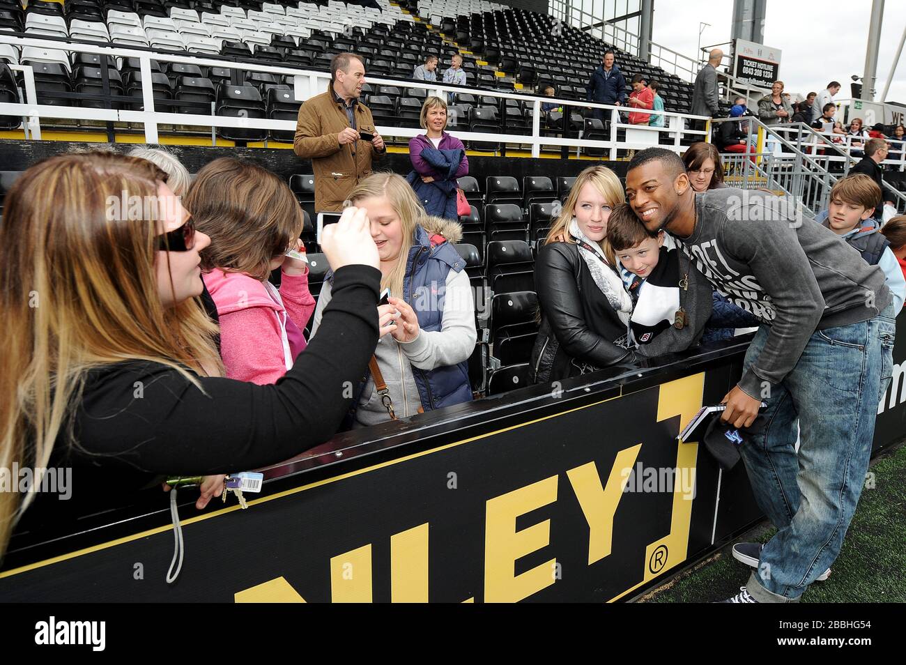JLS singer Oritse poses for photographs with fans before the game Stock ...