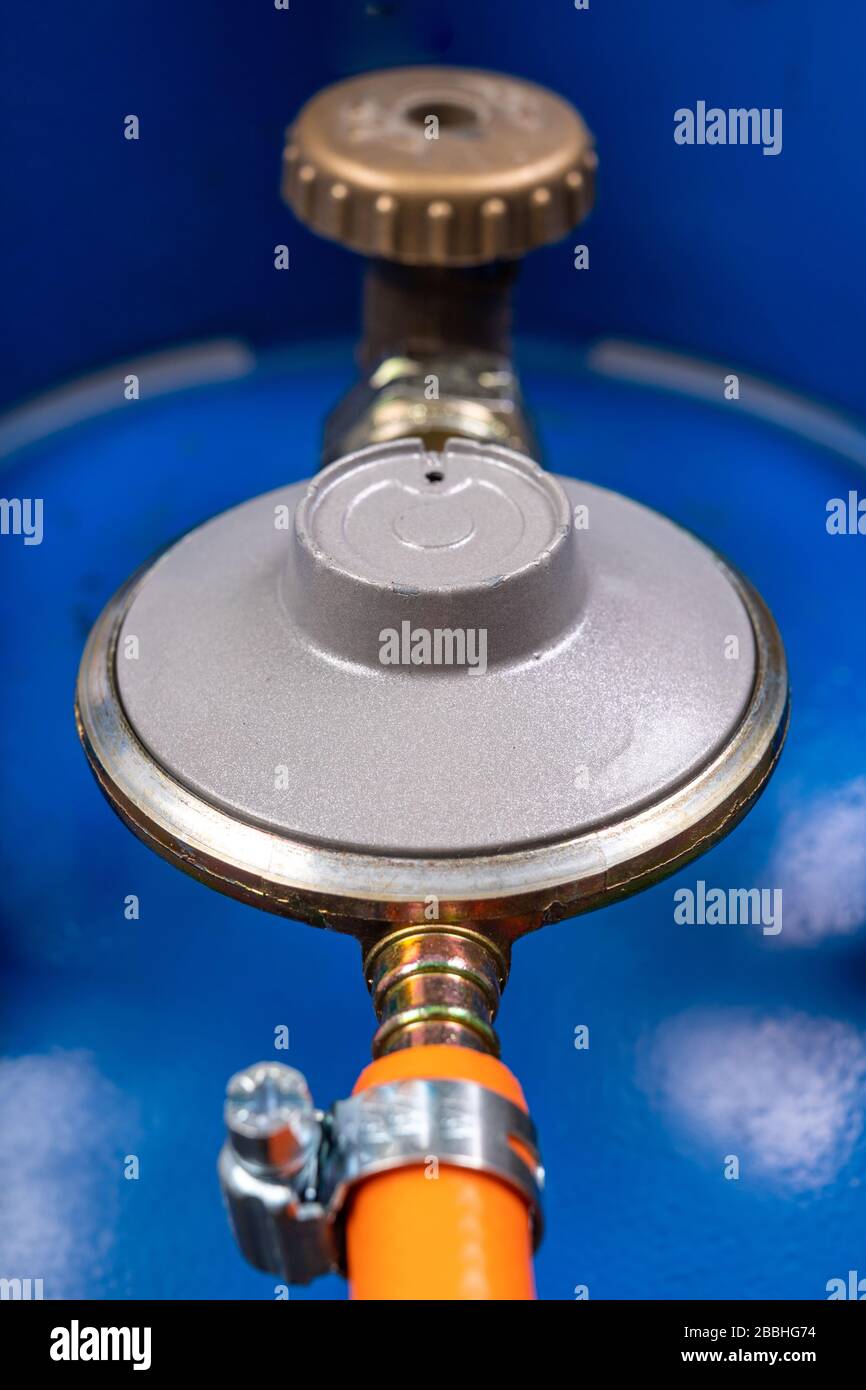 Gas cylinder, reducer. Gas installation accessories. Dark background ...