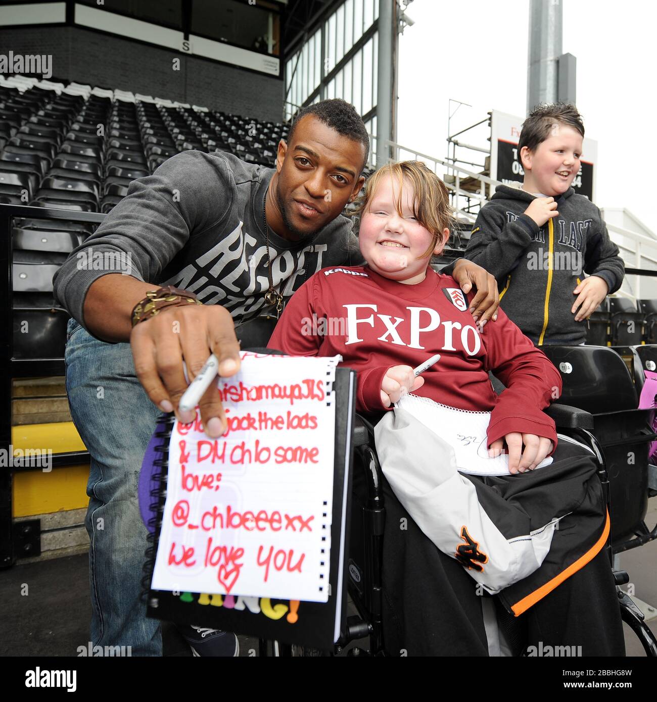 JLS singer Oritse poses for photographs with fans before the game Stock ...