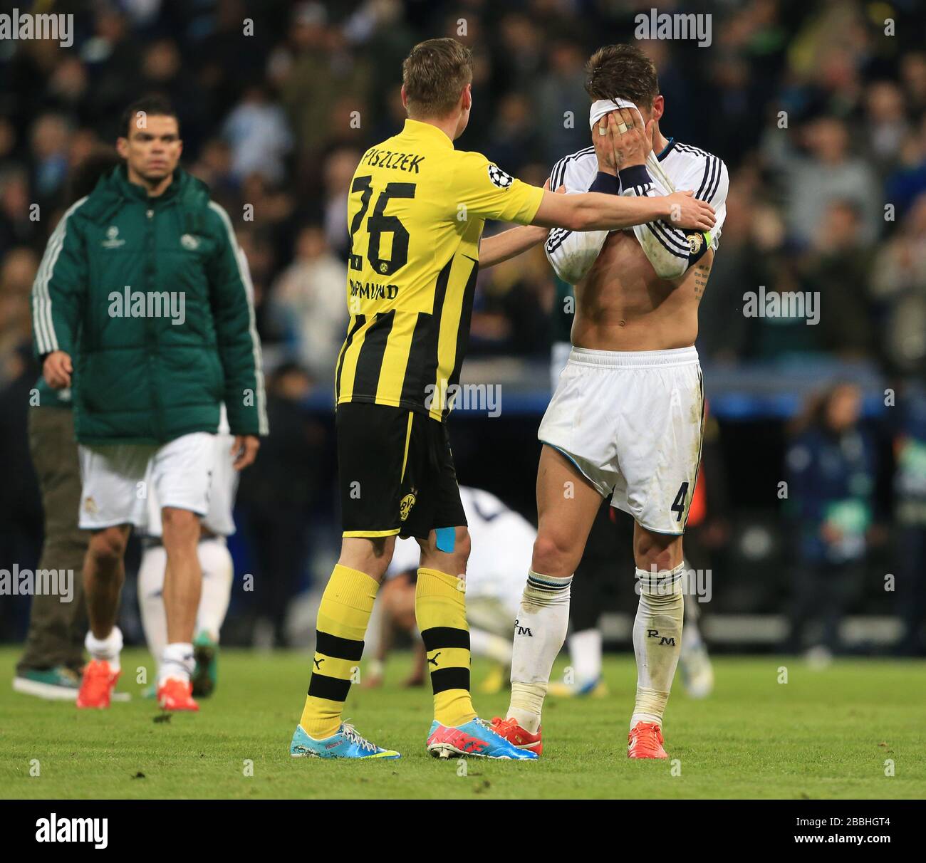 Real Madrid's Sergio Ramos is consoled by Borussia Dortmund's Lukasz ...