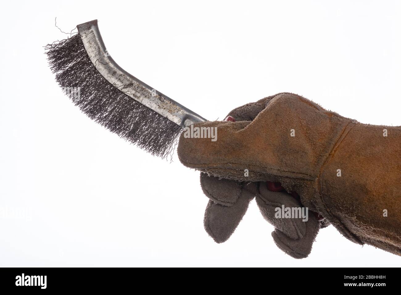 A wire brush for a locksmith held in a glove. Steel cleaning ...