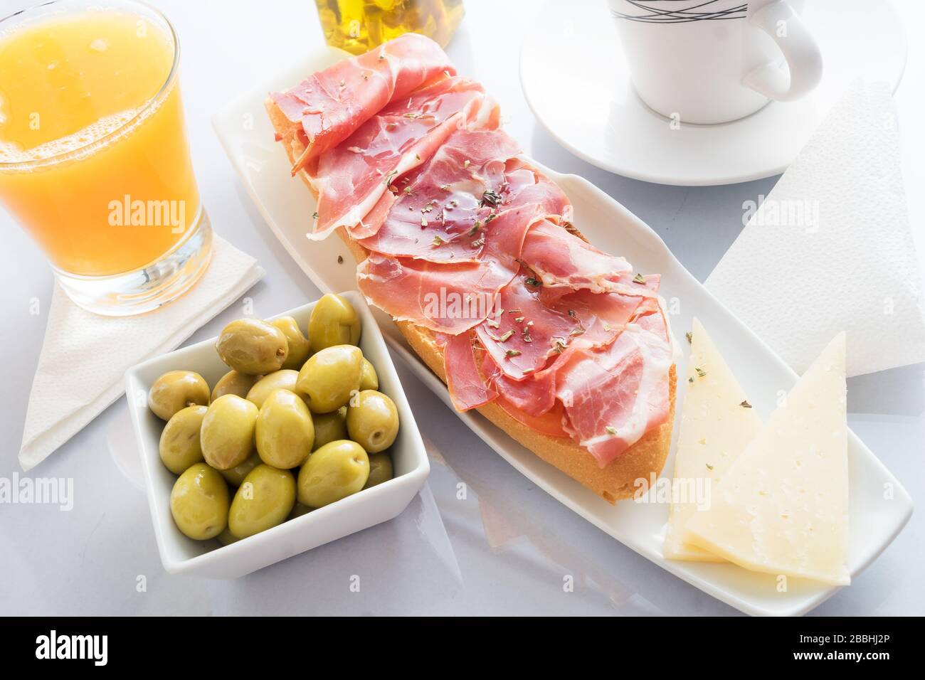 Delicious breakfast toast with hamon orange juice and olives Stock ...