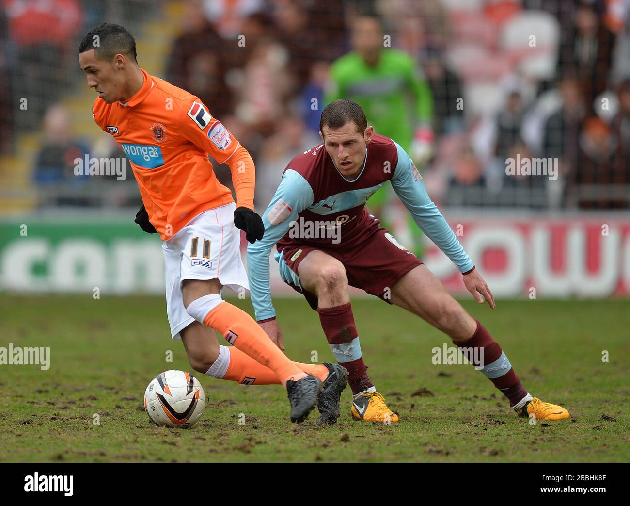 Blackpool's Thomas Ince (left) gets the better of Burnley's Chris ...