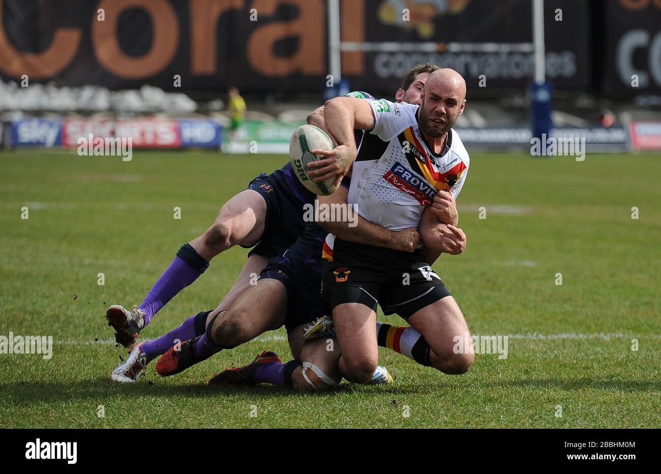 Bradford Bulls' Adrian Purtell (centre) is tackled by Wigan Warriors ...
