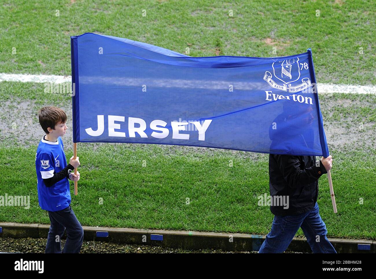 Everton fans from Jersey carry their flag in to the stands before kick ...