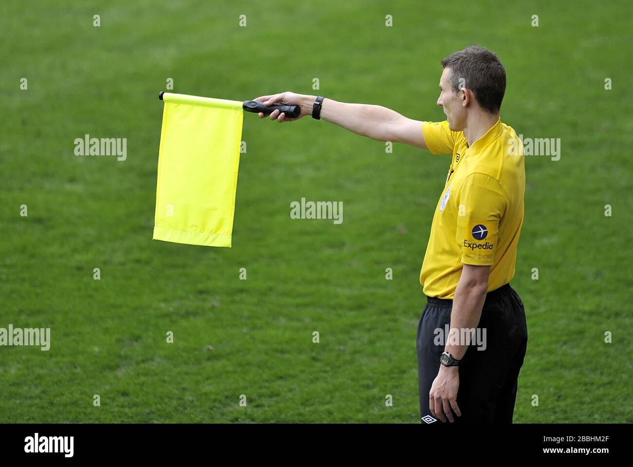 The linesman raises his flag to indicate that a player is offside Stock ...