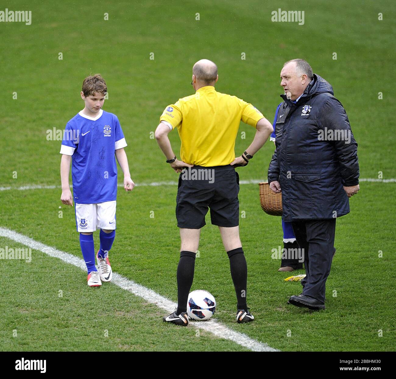 A matchday mascot speaks to the referee before kick-off Stock Photo - Alamy