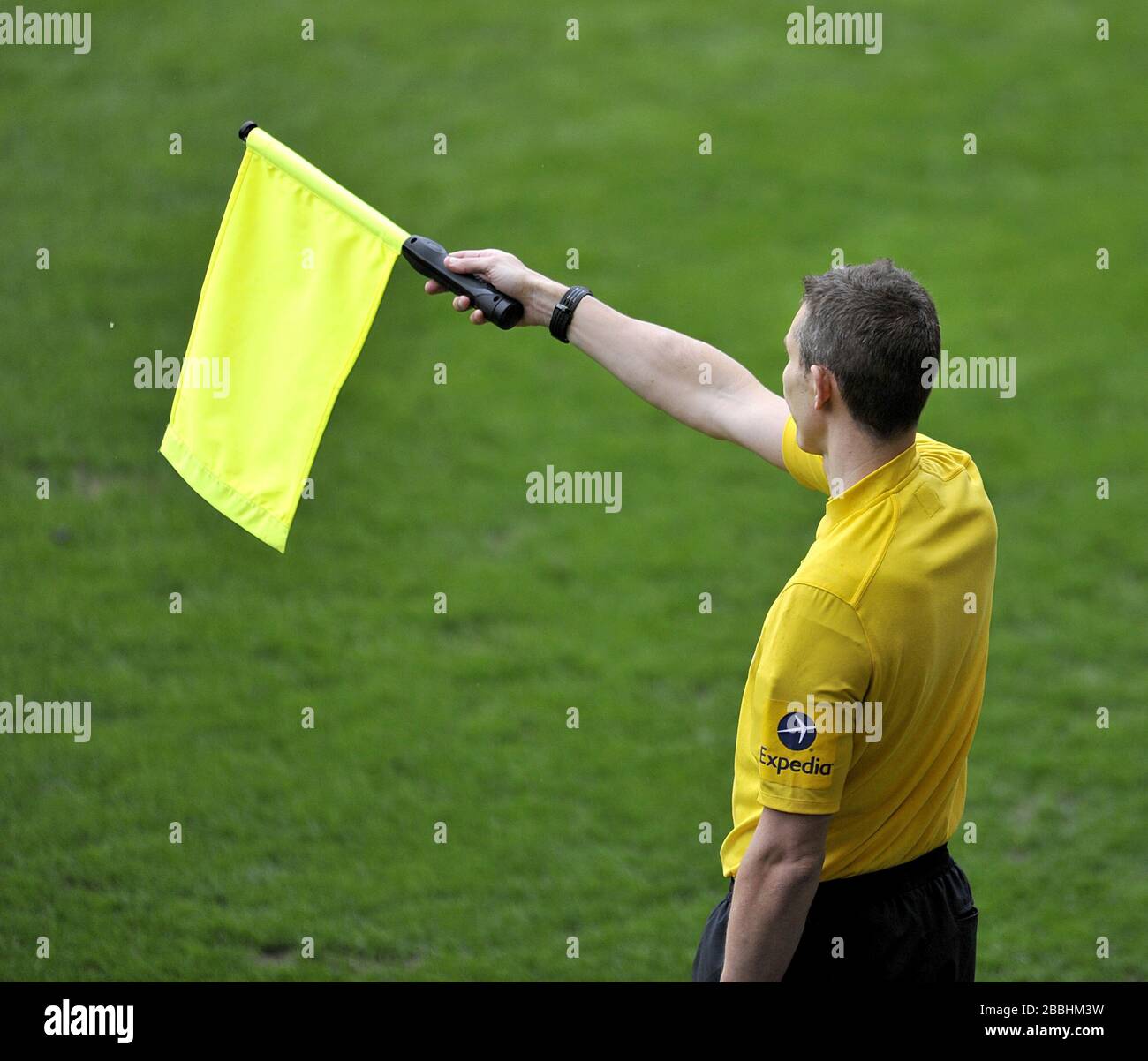 The linesman displays his flag to signal a player is offside Stock Photo - Alamy