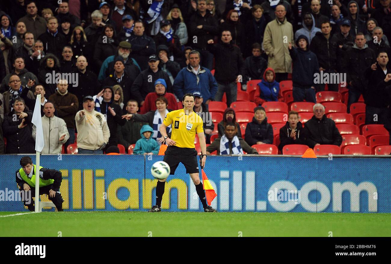The assistant referee and the fans keep a close eye on the ball Stock ...