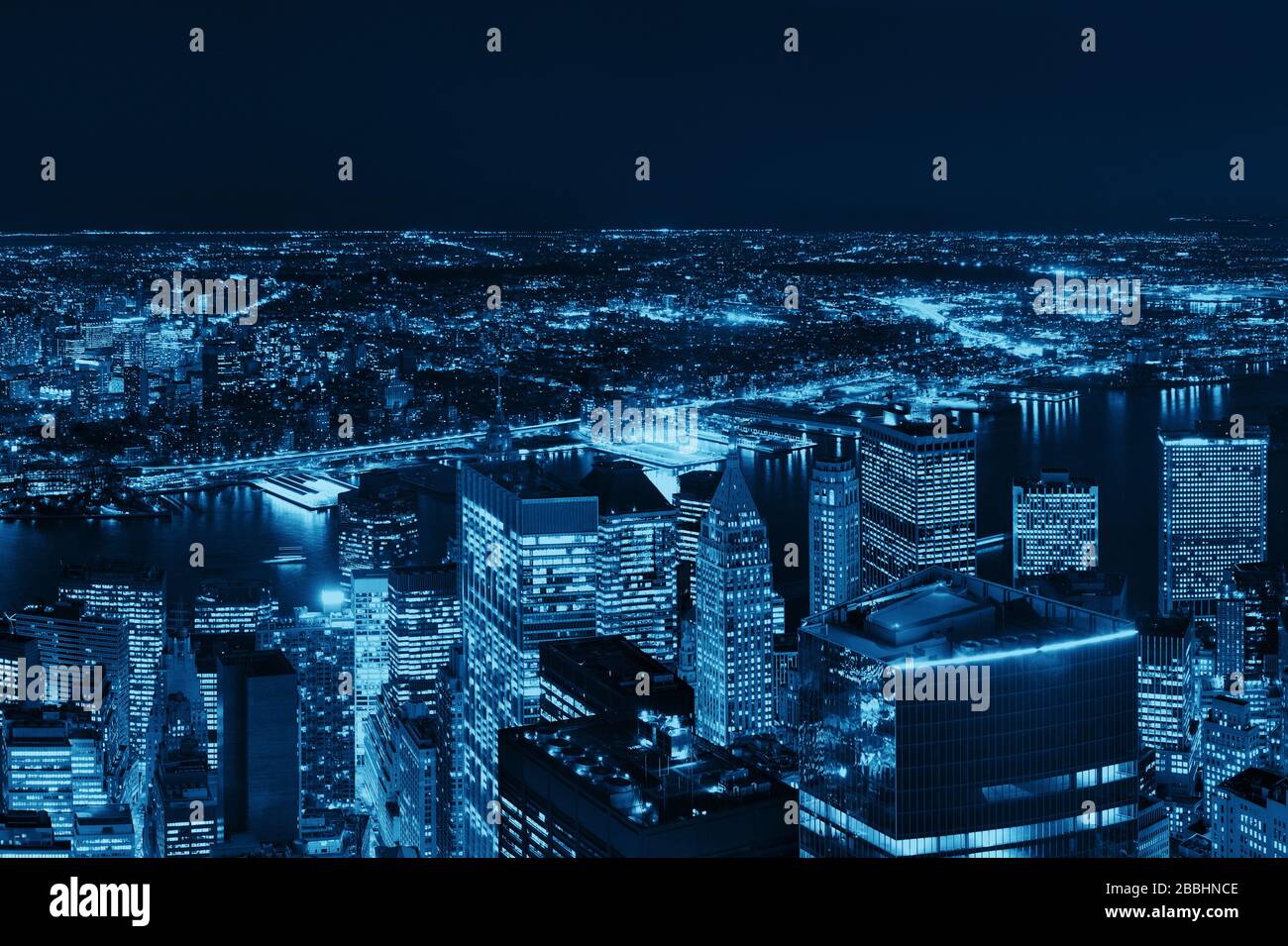 Rooftop night view of New York City downtown with urban skyscrapers ...