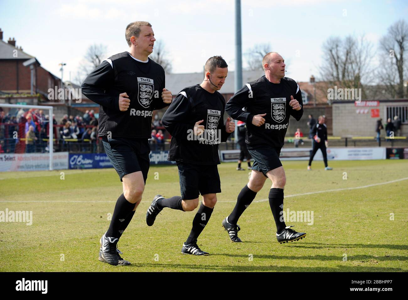 Referee David Webb (centre) and linesmen warm-up prior to the match ...