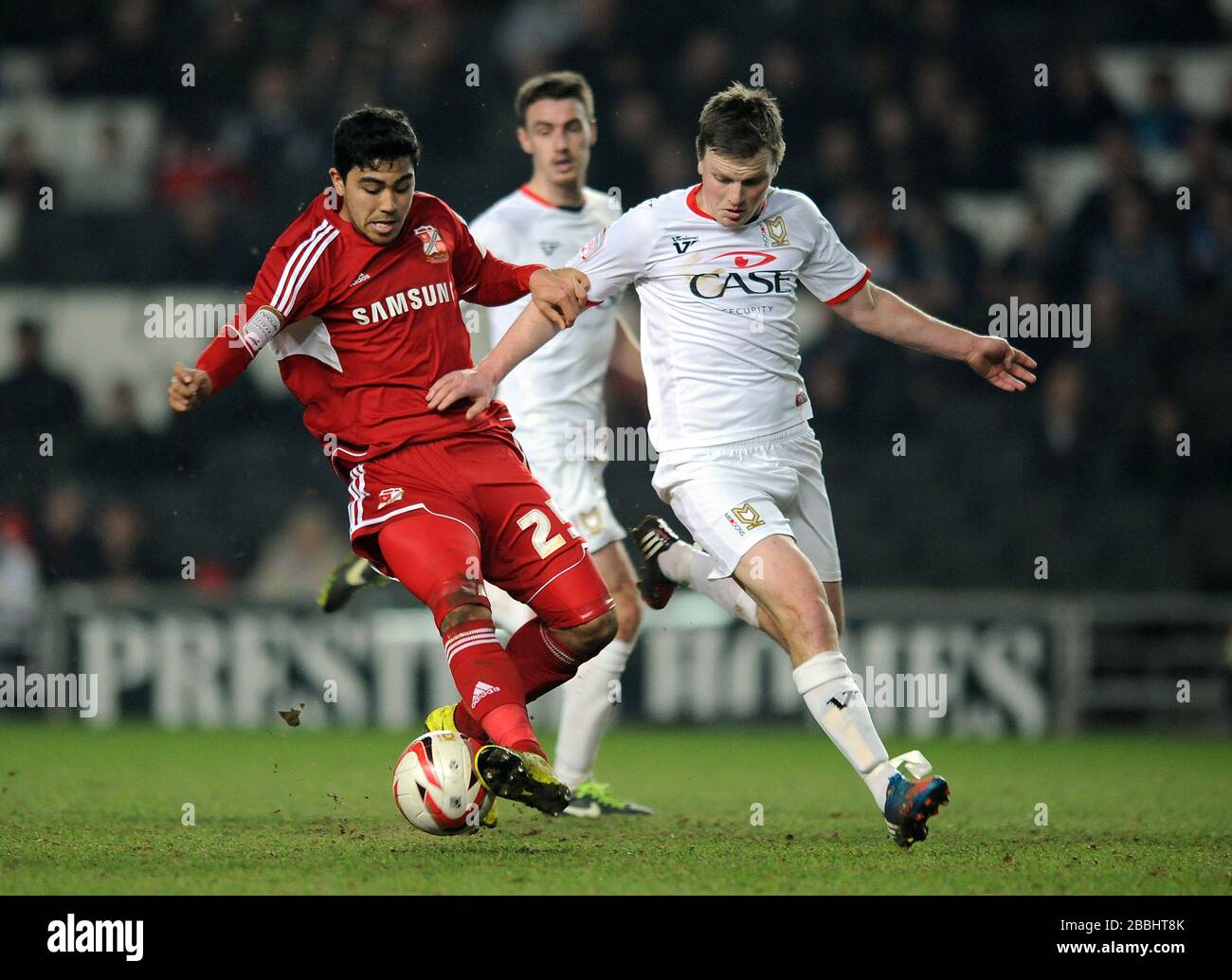 Swindon Town's Massimo Luongo (left) and Milton Keynes Dons' Stephen ...