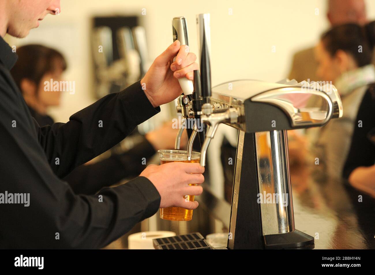 Beer is poured for a guest in the hospitality area Stock Photo - Alamy
