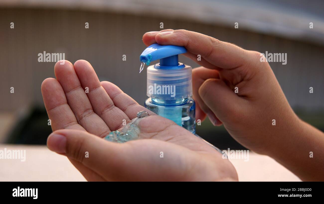 Children washing hands with alcohol based gel to protect from corona ...