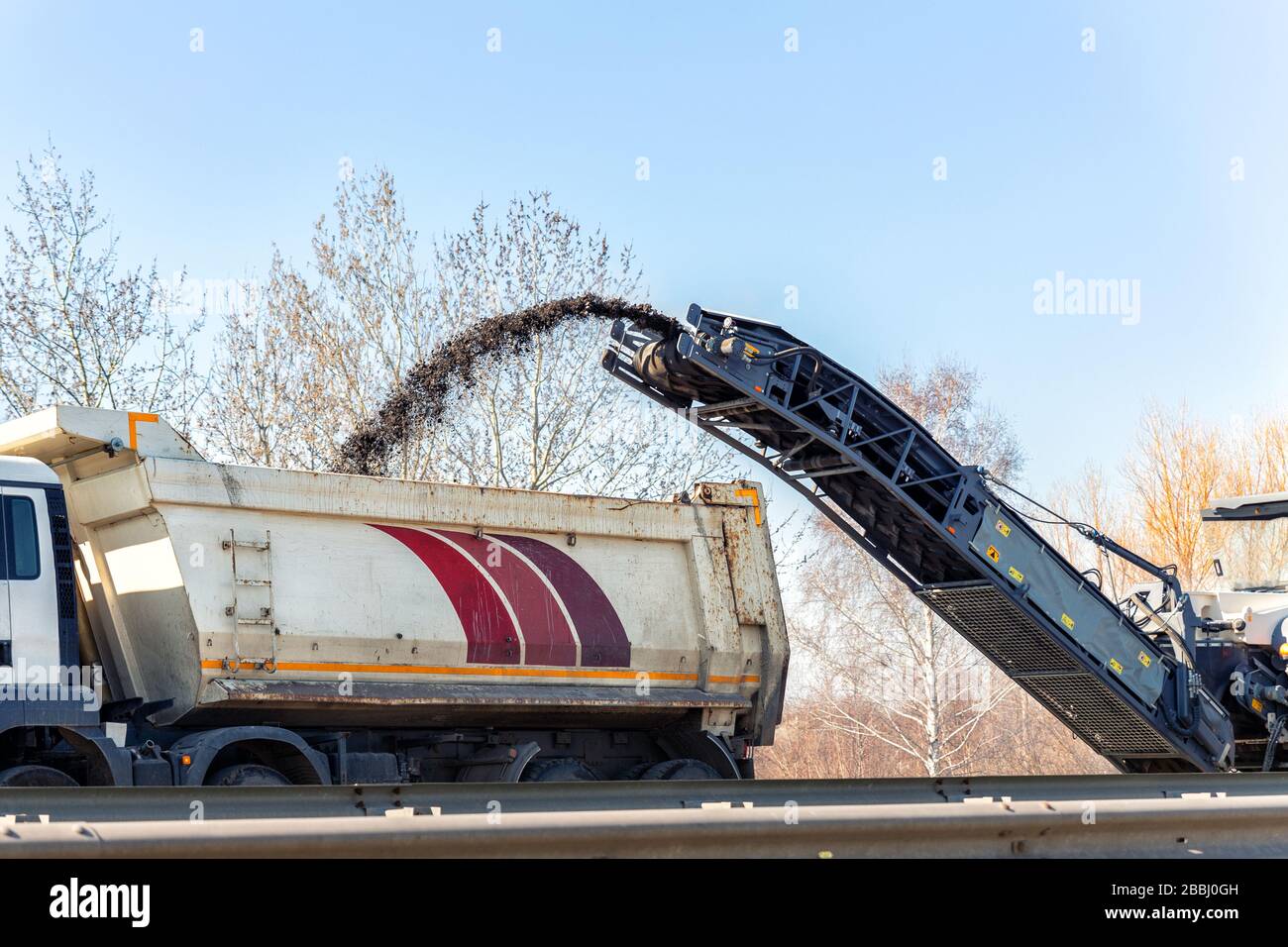 Asphalt milling and grinding machine at road repair and construction ...