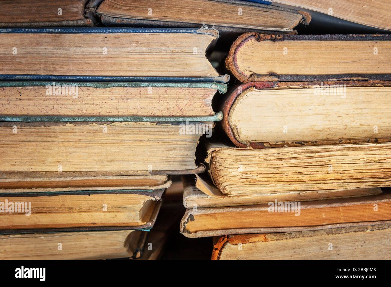 stack of old books on a library shelf Stock Photo - Alamy
