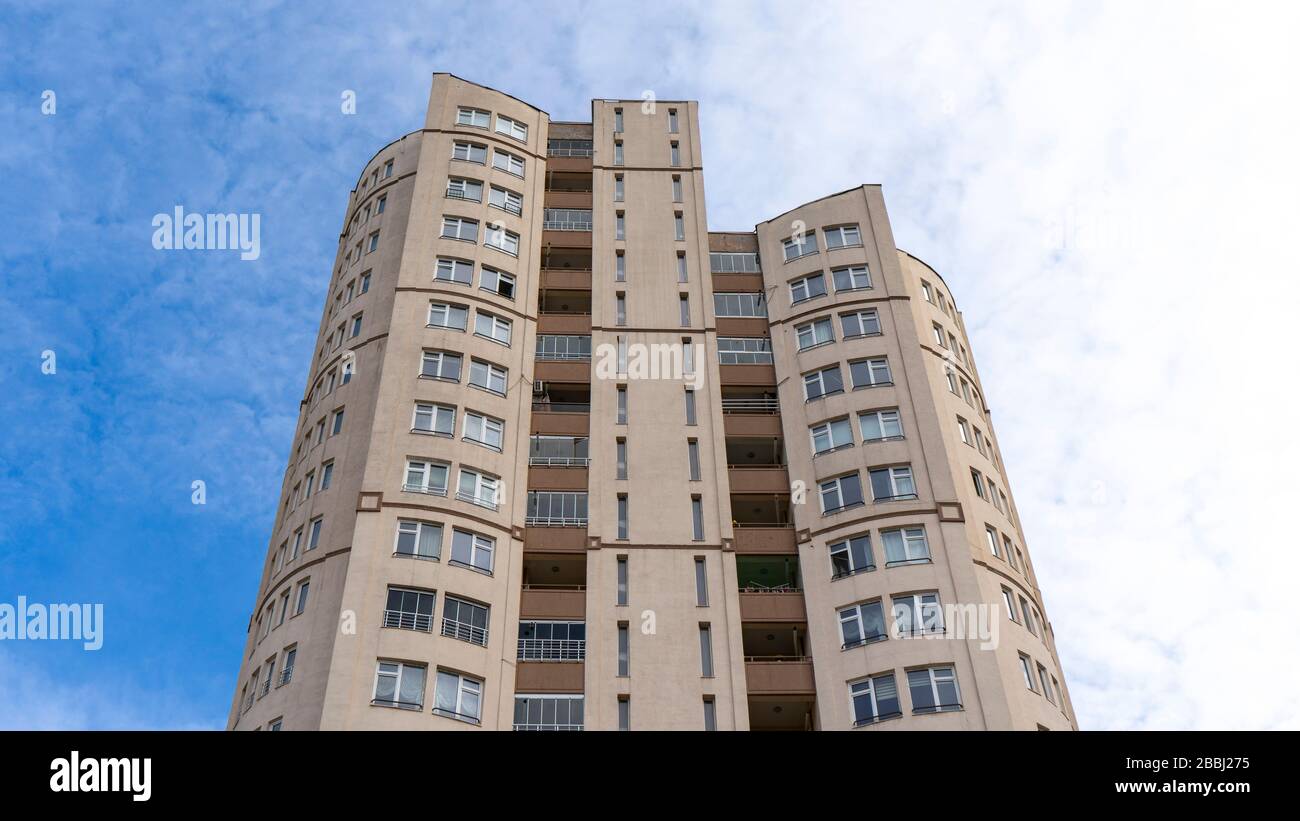 Very ugly building is in metropol city. There are clouds on blue sky in ...