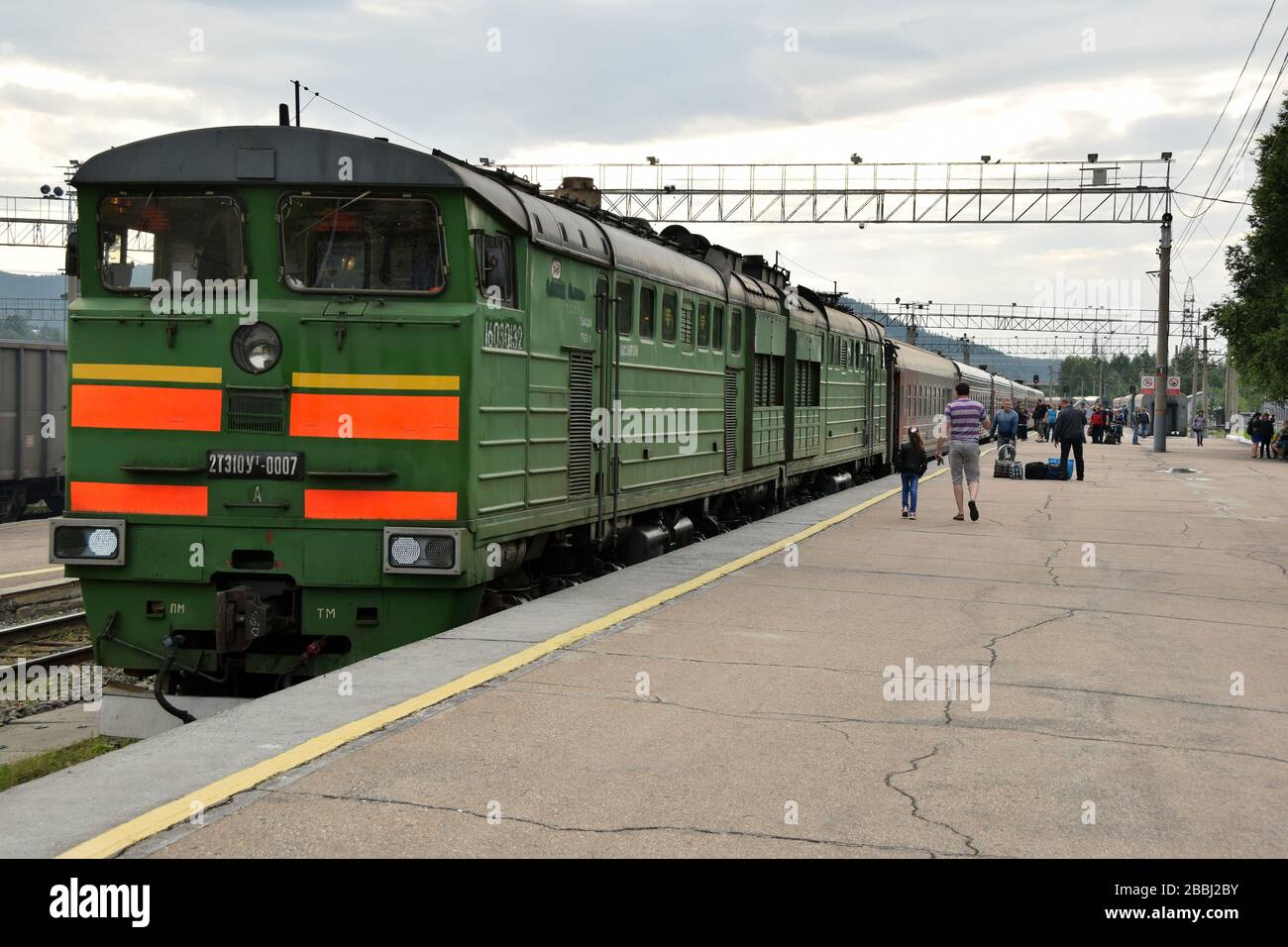 A passenger train during a stop in the railway station of Tynda, Russia ...