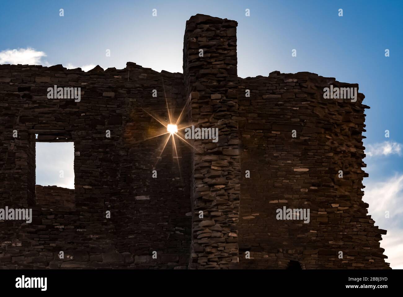 Sun shining through a hole in one of the buildings at Pueblo Bonito in ...