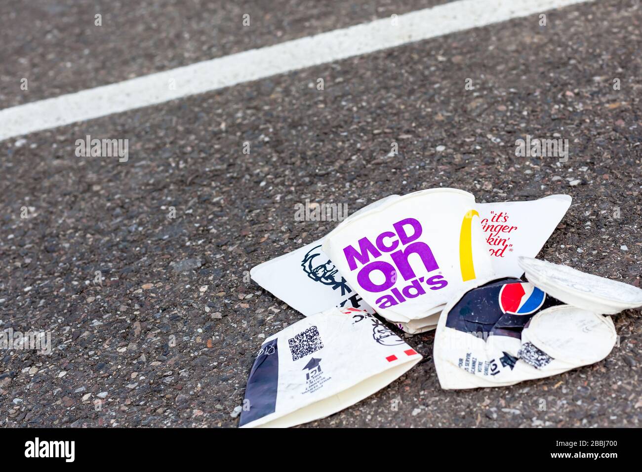 Disposable fast food cups garbage on asphalt street road. Ecological ...