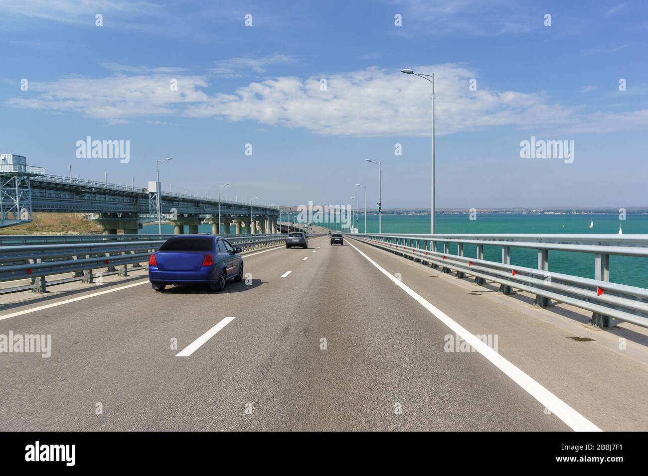 Crimean bridge across the Kerch Strait. Cars descend from the height of ...