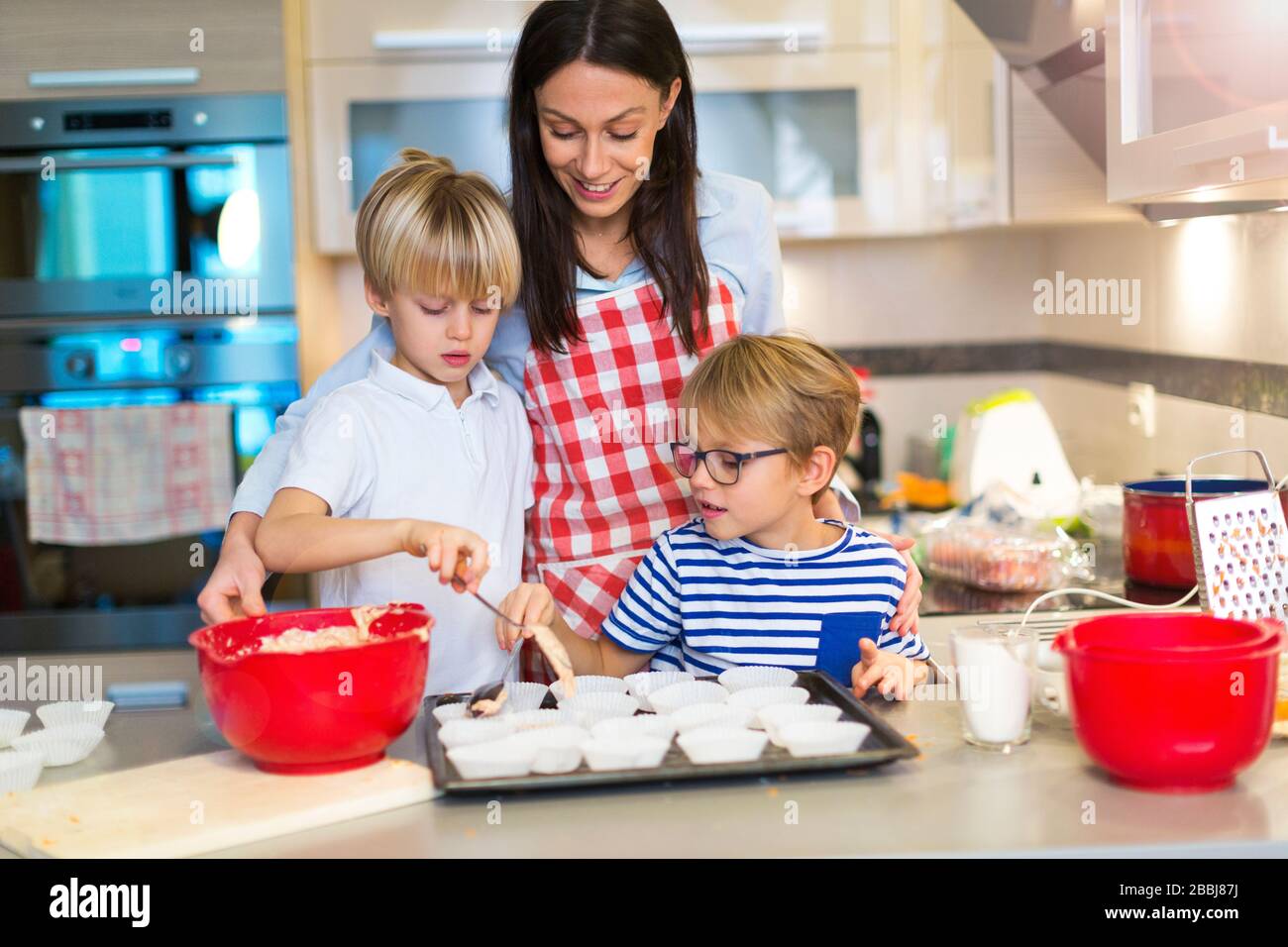 Mother and children cooking at home Stock Photo - Alamy
