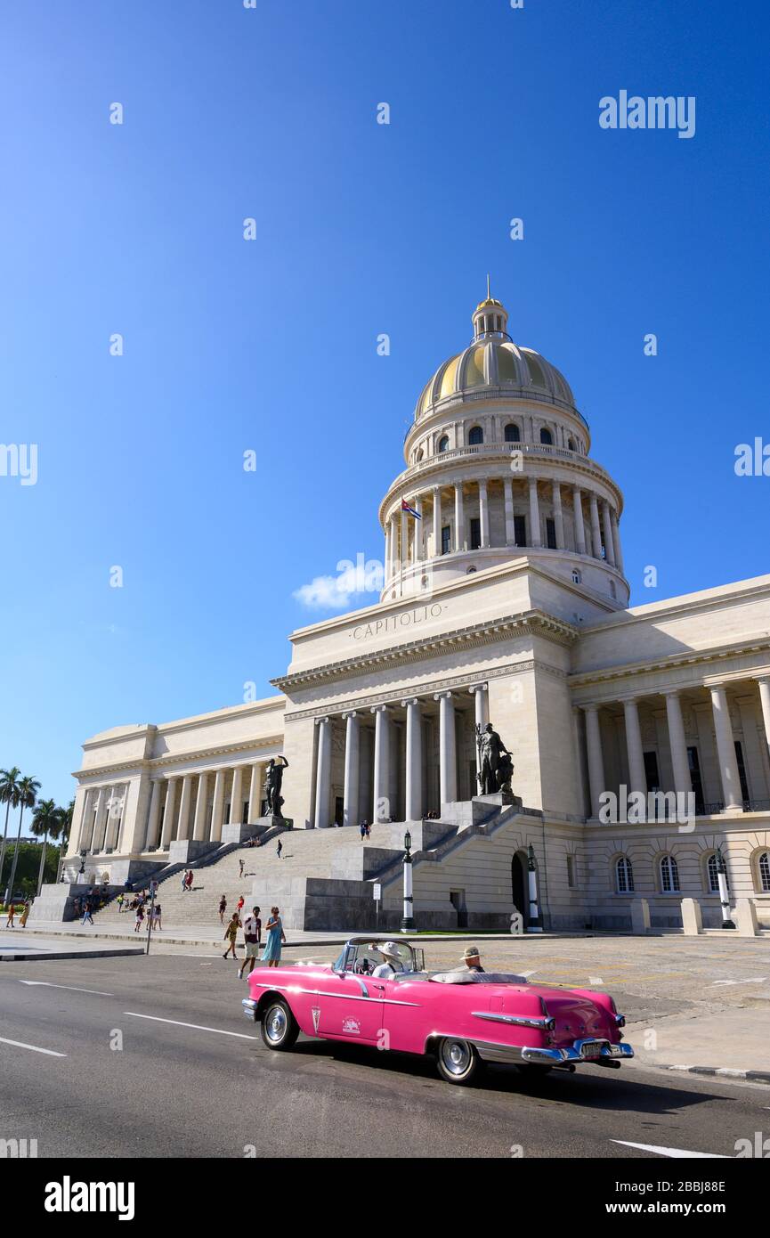 Classic car in pink, El Capitolio, or the National Capitol Building ...