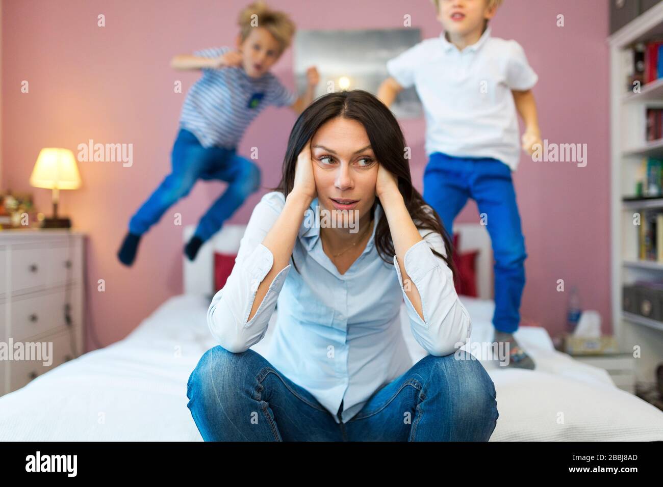Frustrated mother with children at home Stock Photo - Alamy