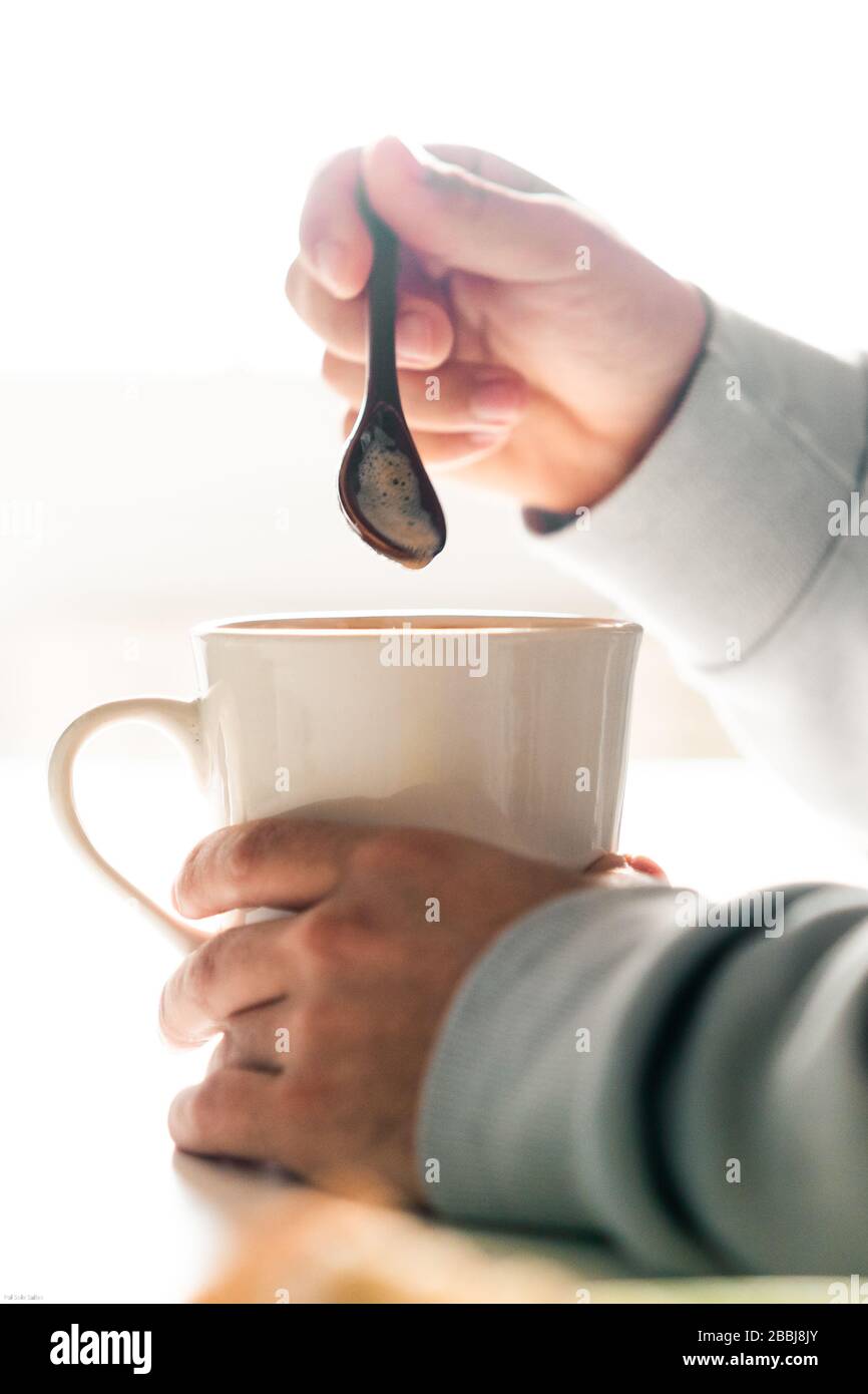 Stirring a cup of coffee hi-res stock photography and images - Alamy