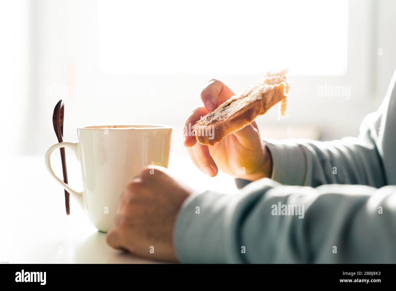 Person having lunch eating a toast with a cup of coffee Stock Photo - Alamy