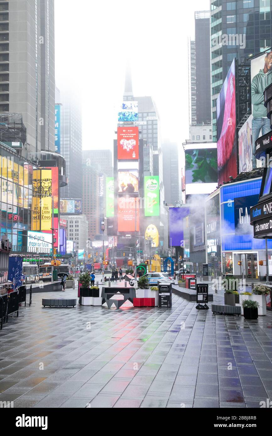 A quiet rainy day in Times Square during the coronavirus pandemic Stock ...
