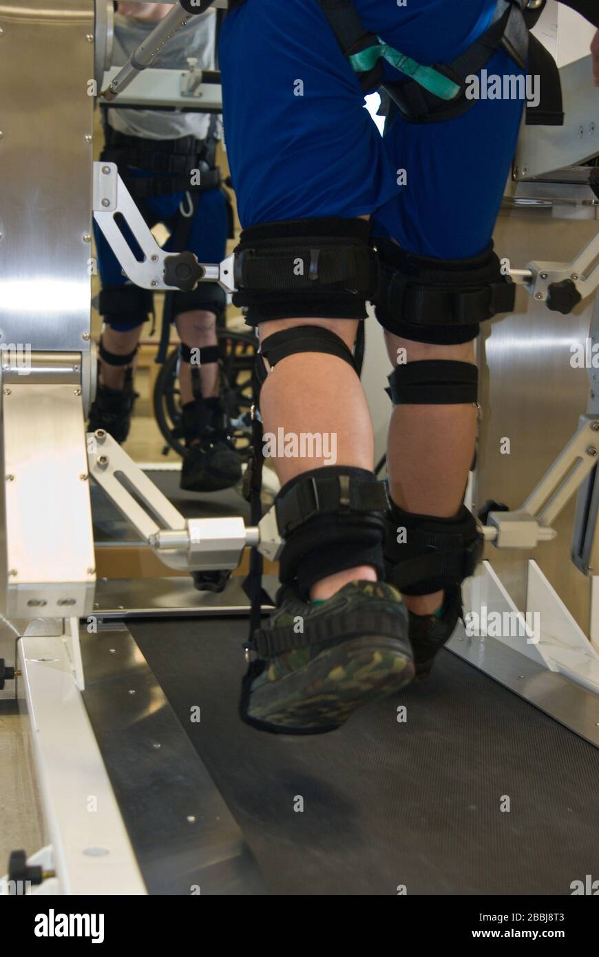 Partial view of a man in physical therapy on a machine that assists ...