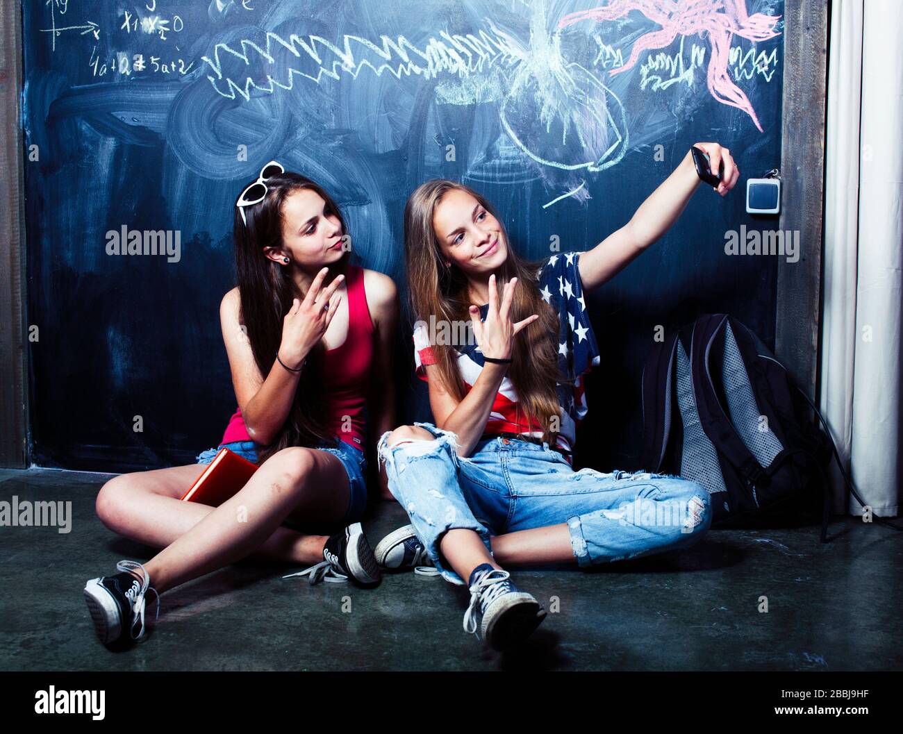 back to school after summer vacations, two teen real girls in classroom ...