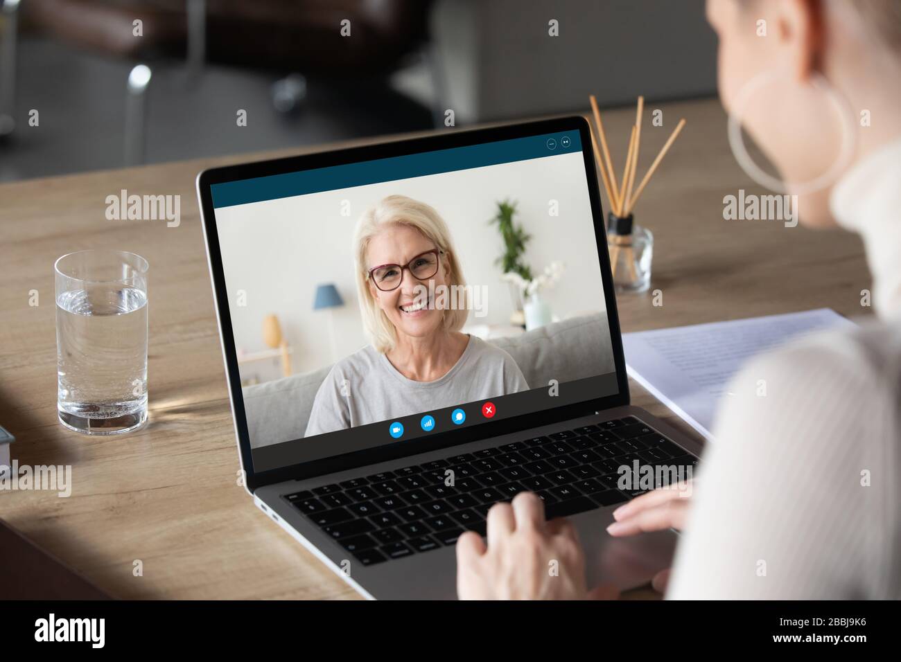 Back view of woman speak talk on video call on computer with smiling ...