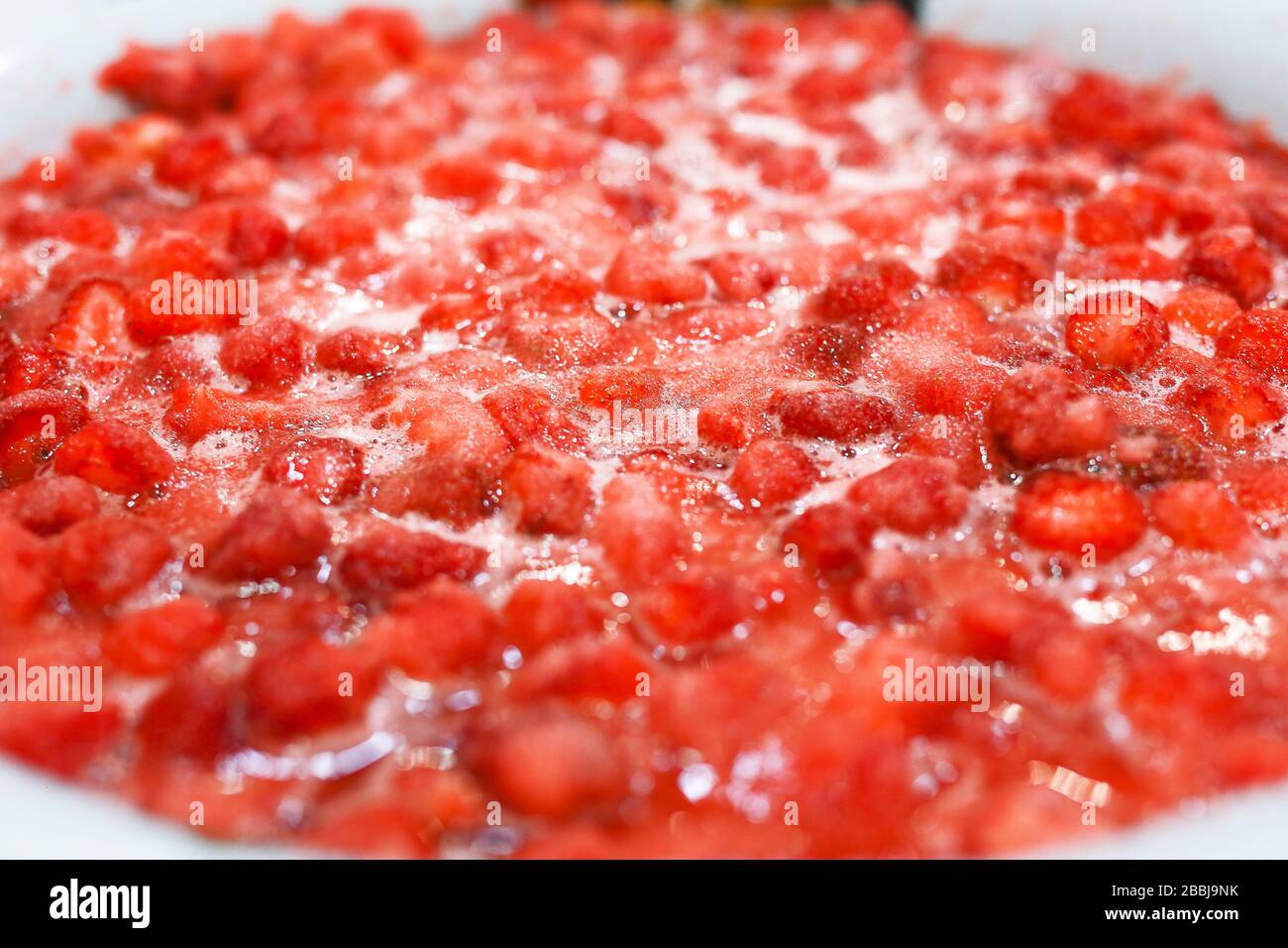 Strawberry jam cooking process. Organic traditional jam manufacturing ...